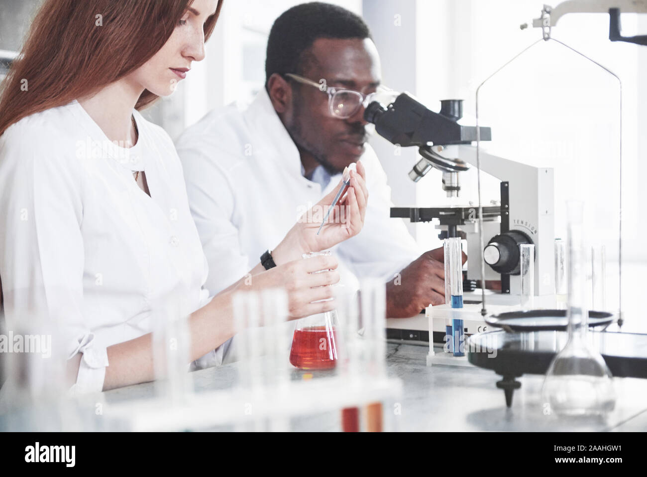 Scientists work closely with the microscope in the laboratory by ...