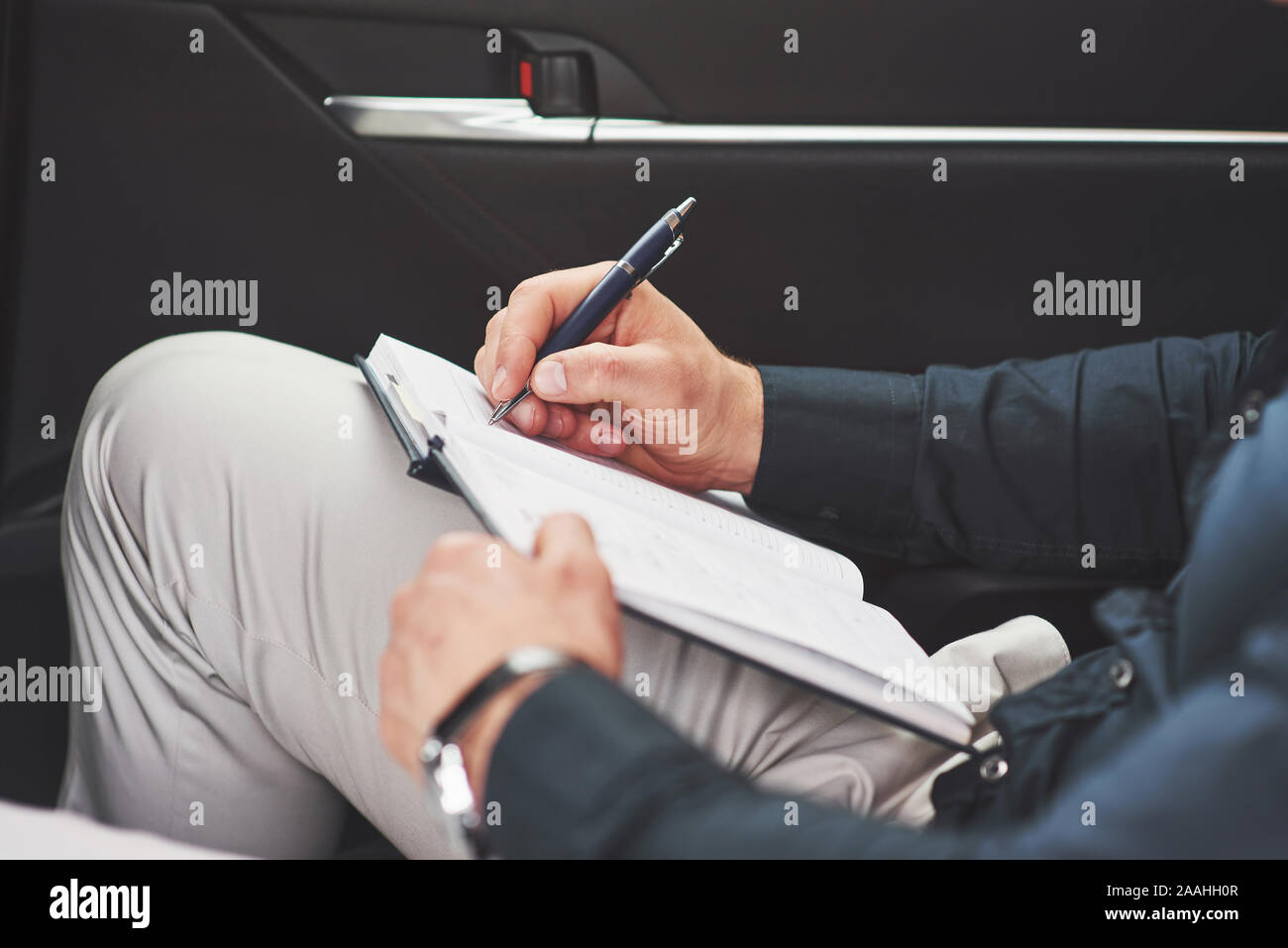 Business Hand Writing Notes car seat Stock Photo - Alamy