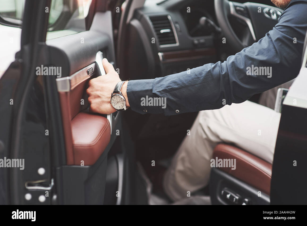 Beautiful young man in full suit while driving a car Stock Photo - Alamy