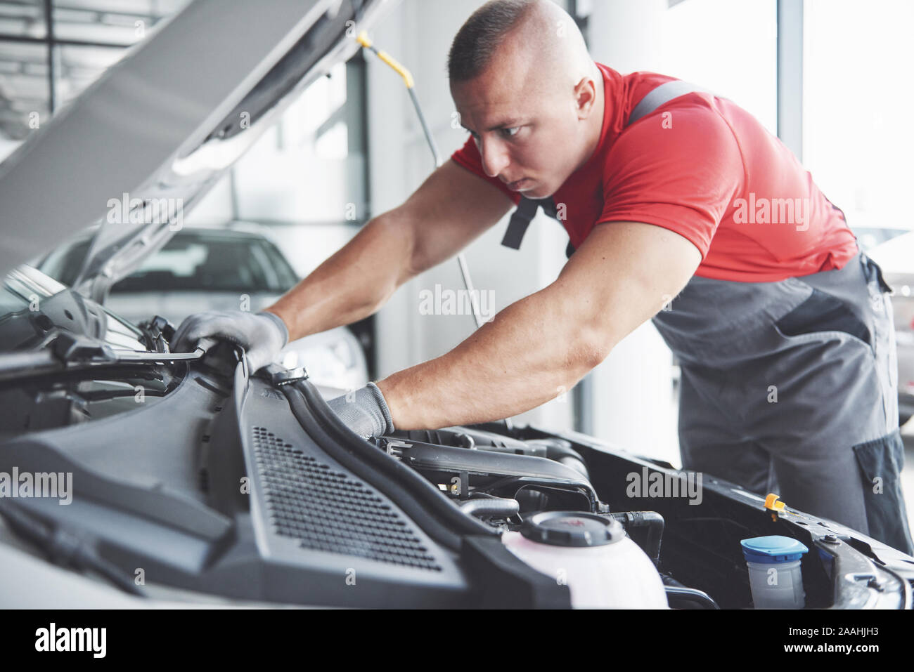 Picture showing muscular car service worker repairing vehicle Stock ...