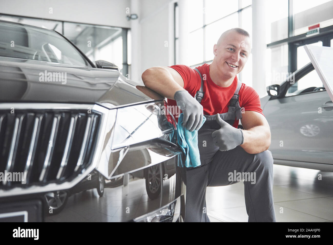 Professional cleaning and car wash in the car showroom Stock Photo - Alamy