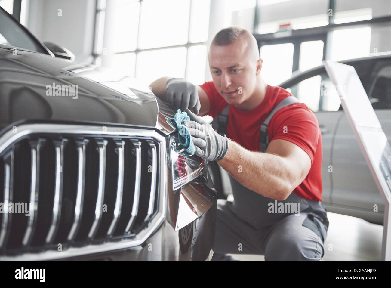 Professional cleaning and car wash in the car showroom Stock Photo - Alamy