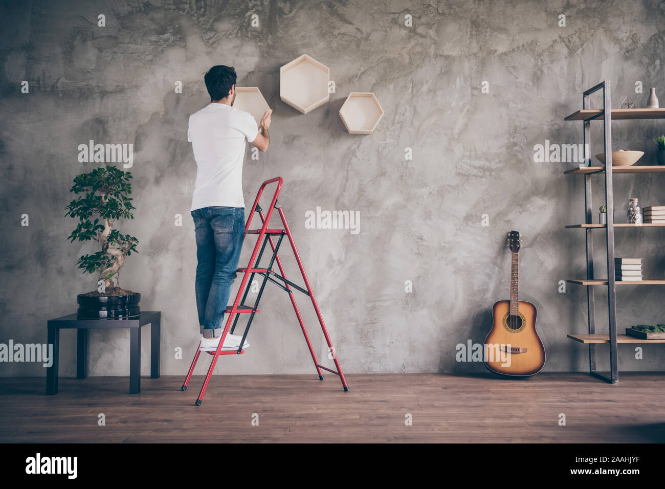 Full length rear behind view photo of mixed race arabian guy installing ...