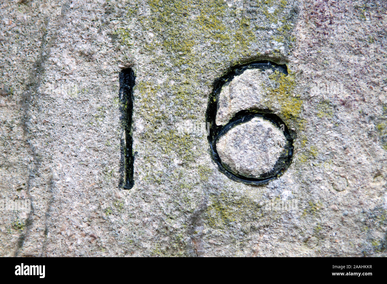 A Close Up Of The Number Sixteen Craved In Stone And Highlighted In ...