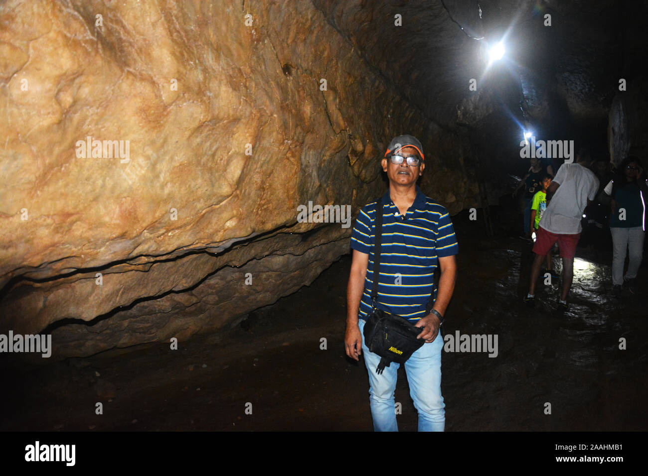 Close up of a tourist wearing cap and spectacles posing inside the ...