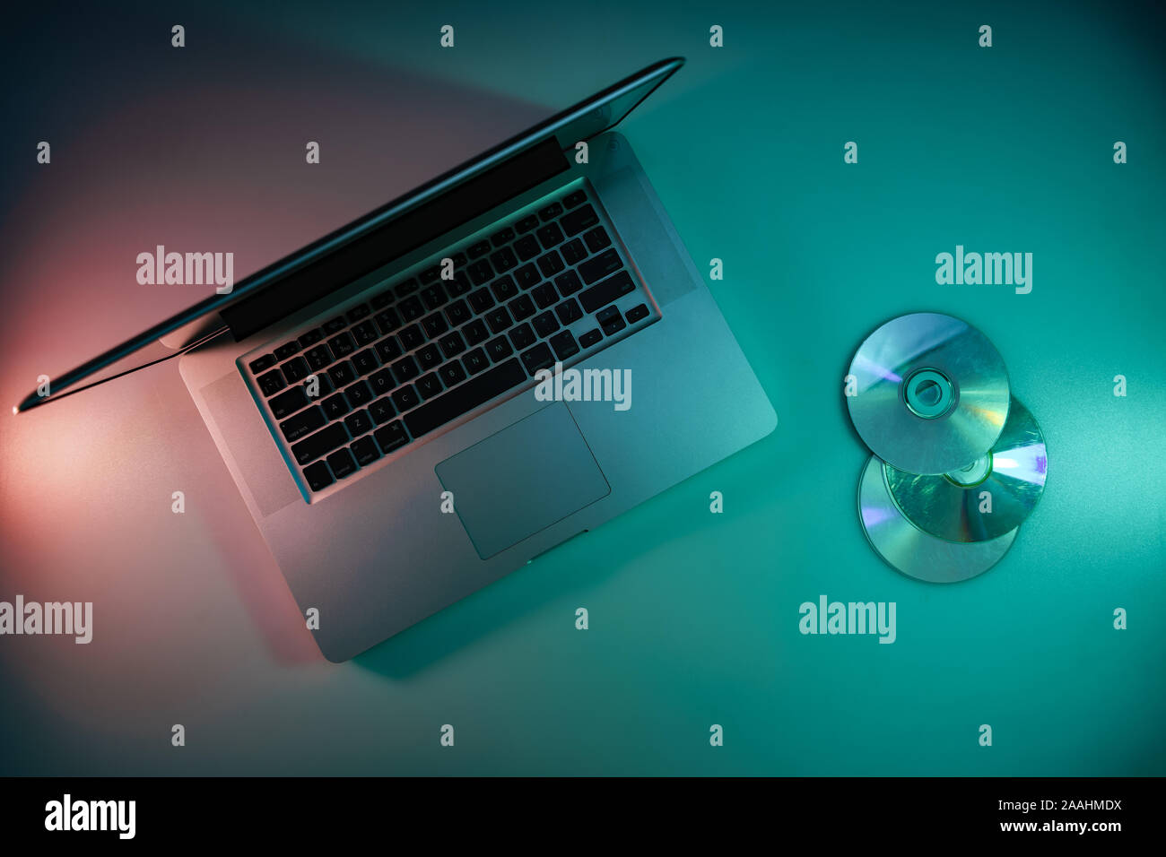 Beautiful silver laptop in the color light on a table and night ...