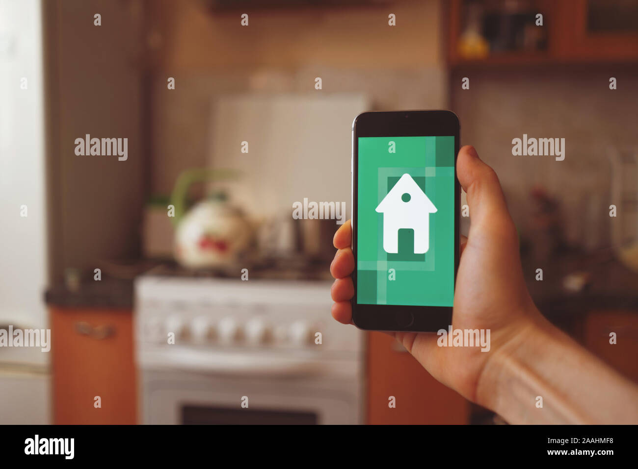 hand holding smartphone with smart home application, modern technology ...