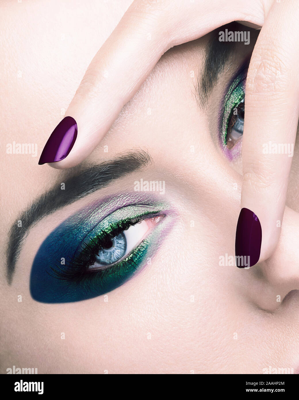 Beautiful young woman covering eye with fingers Stock Photo - Alamy