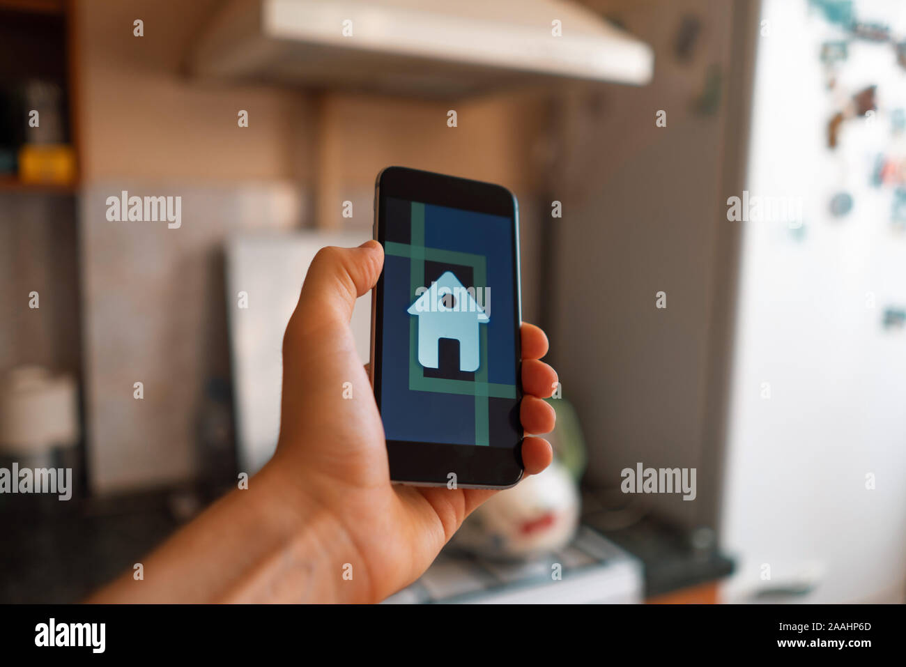 hand holding smartphone with smart home application, modern technology ...