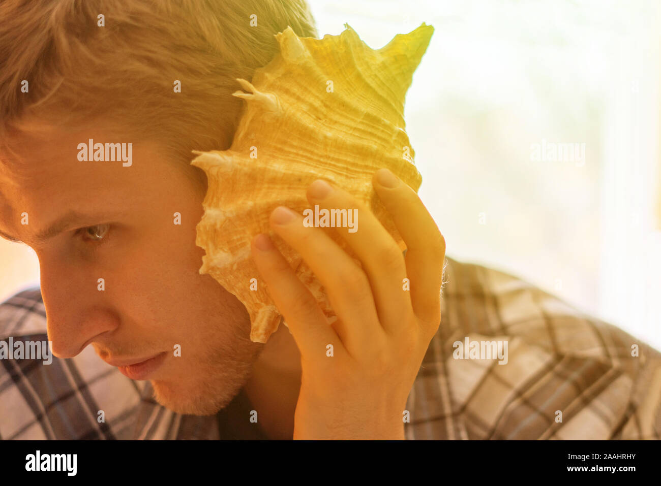 Boy listen shell hi-res stock photography and images - Alamy