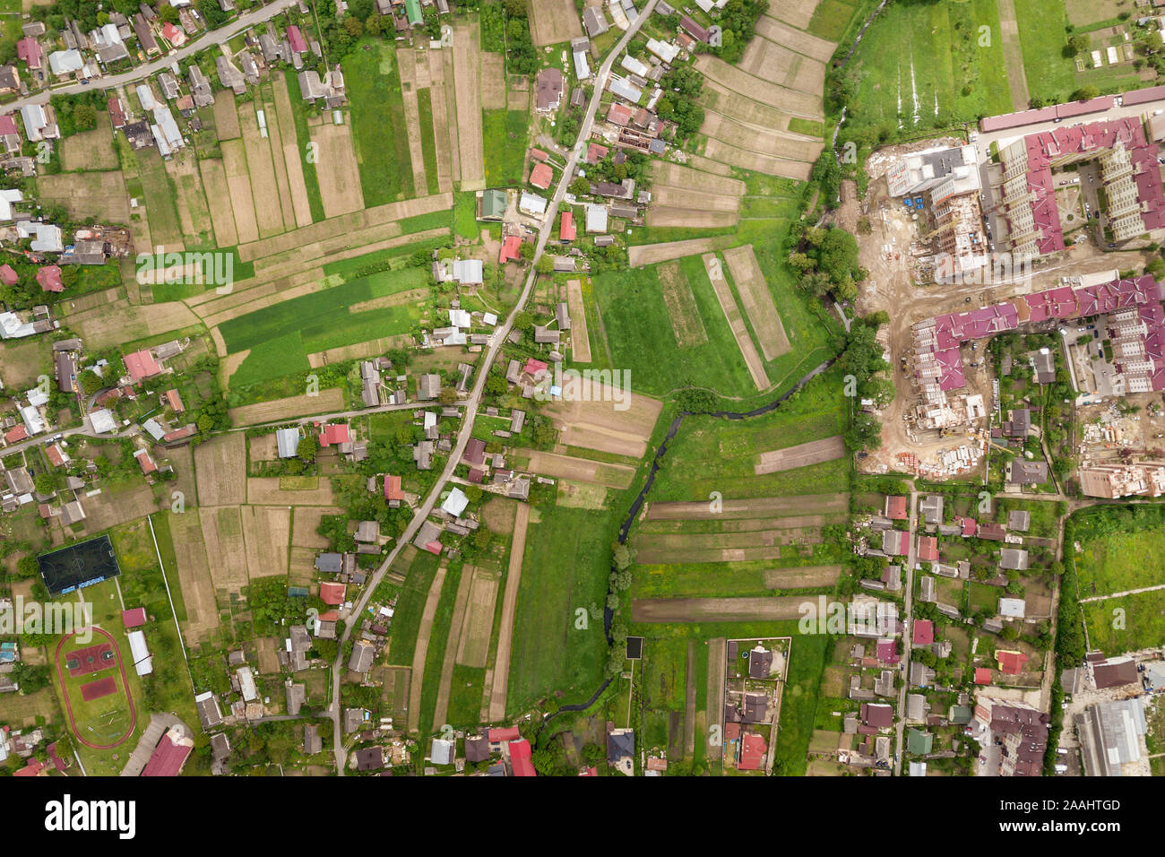 Top down aerial view of town or village with rows of buildings and ...