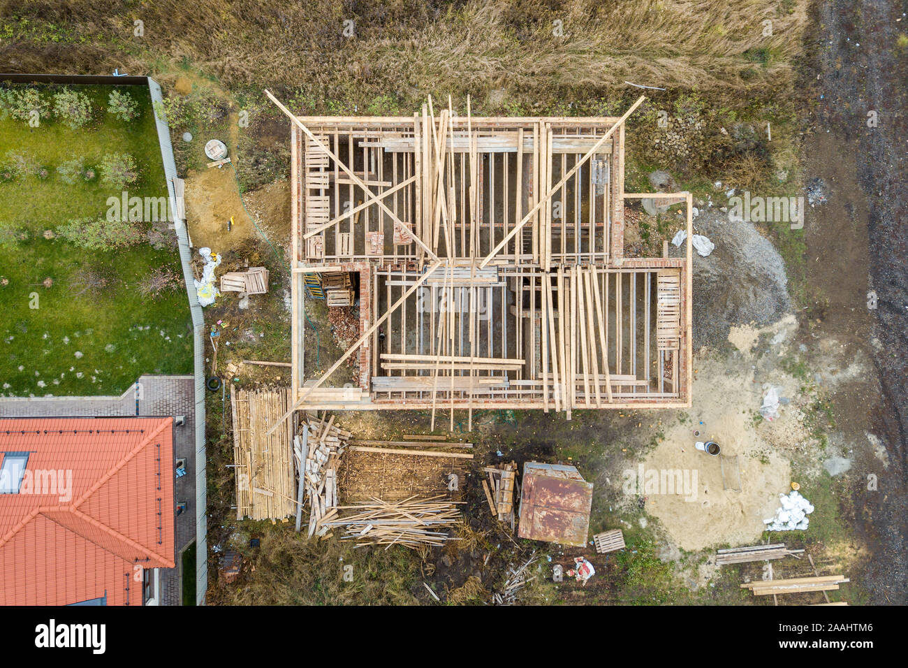 Top down aerial view of a house under construction with wooden roof ...