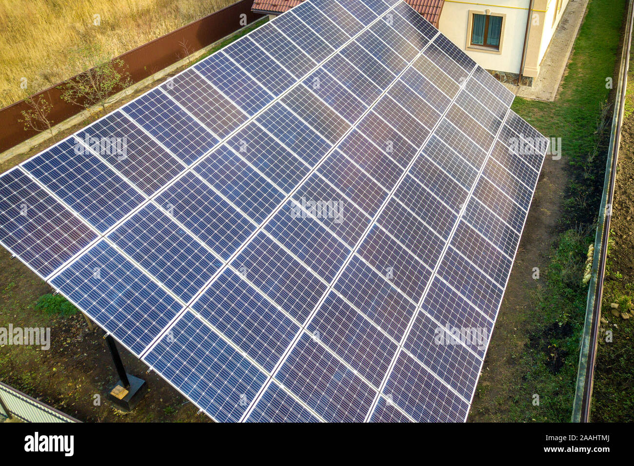 Aerial view of big blue solar panel installed on ground structure near ...