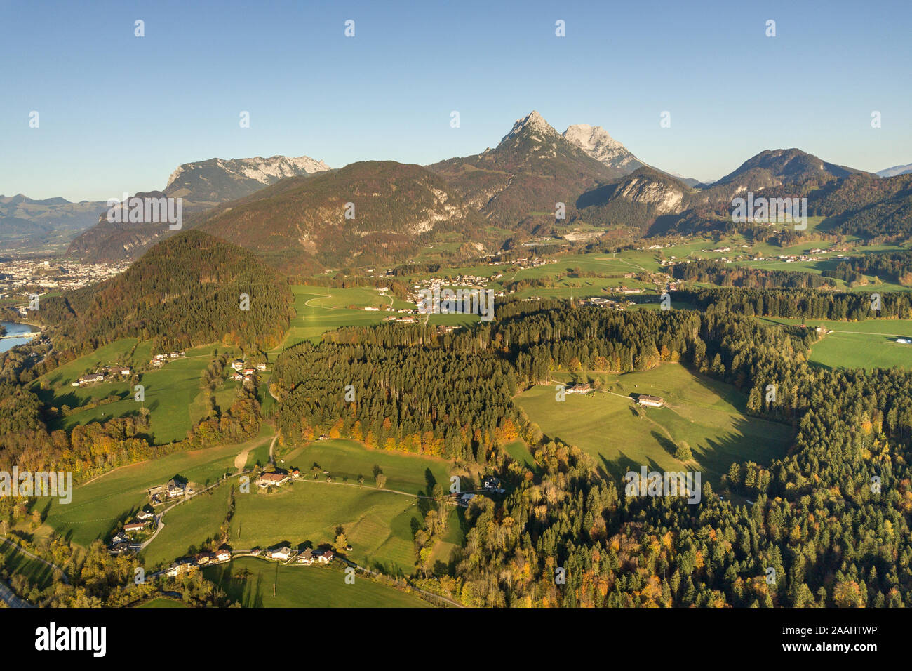 Aerial view of green meadows with villages and forest in austrian Alps ...