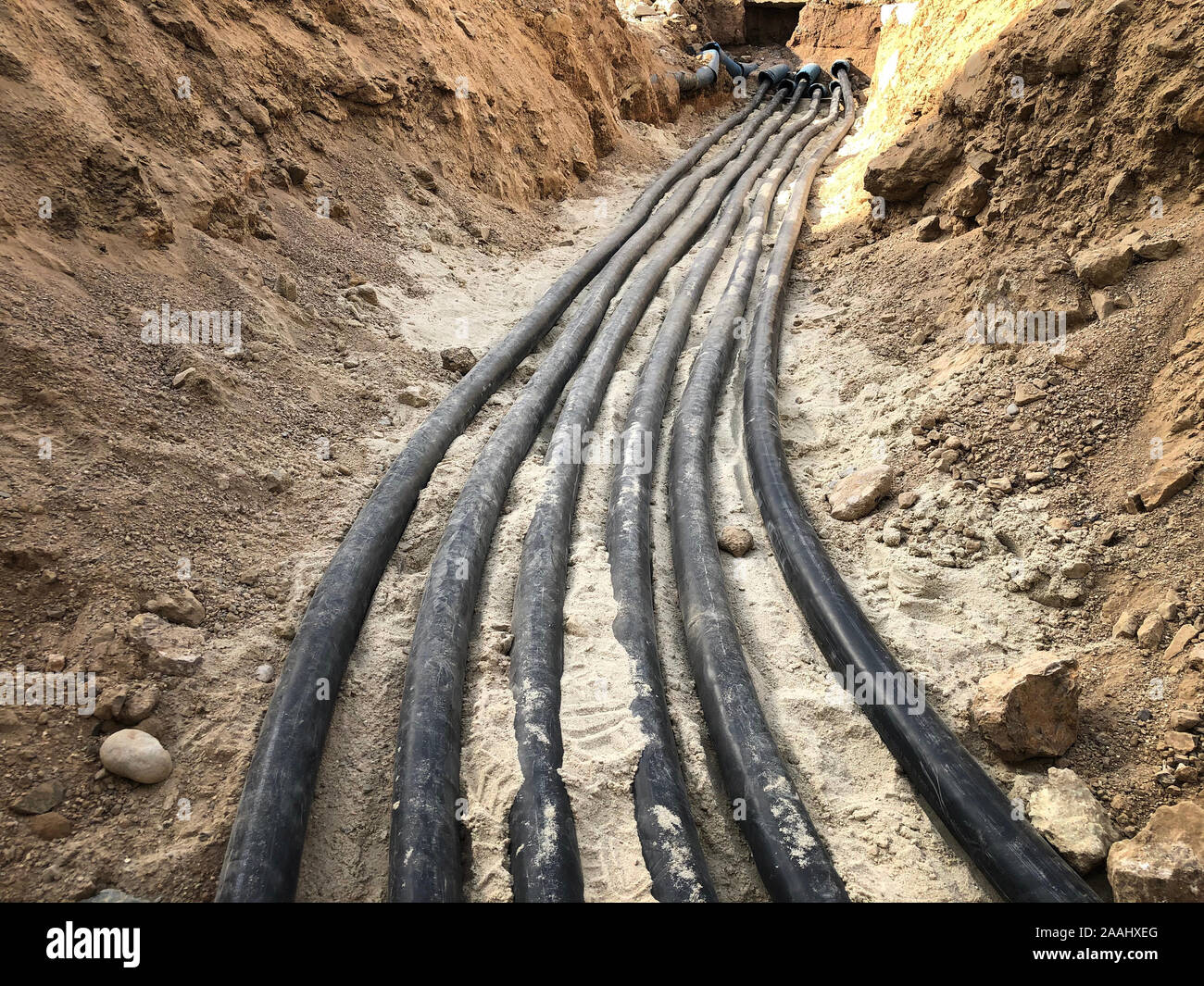 The high voltage electrical cable is laid in a trench Stock Photo - Alamy