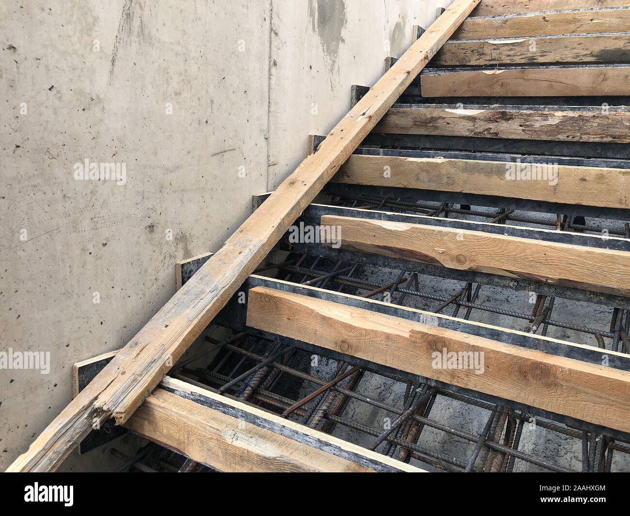 Metal reinforcement and wooden formworks of concrete stairway under ...