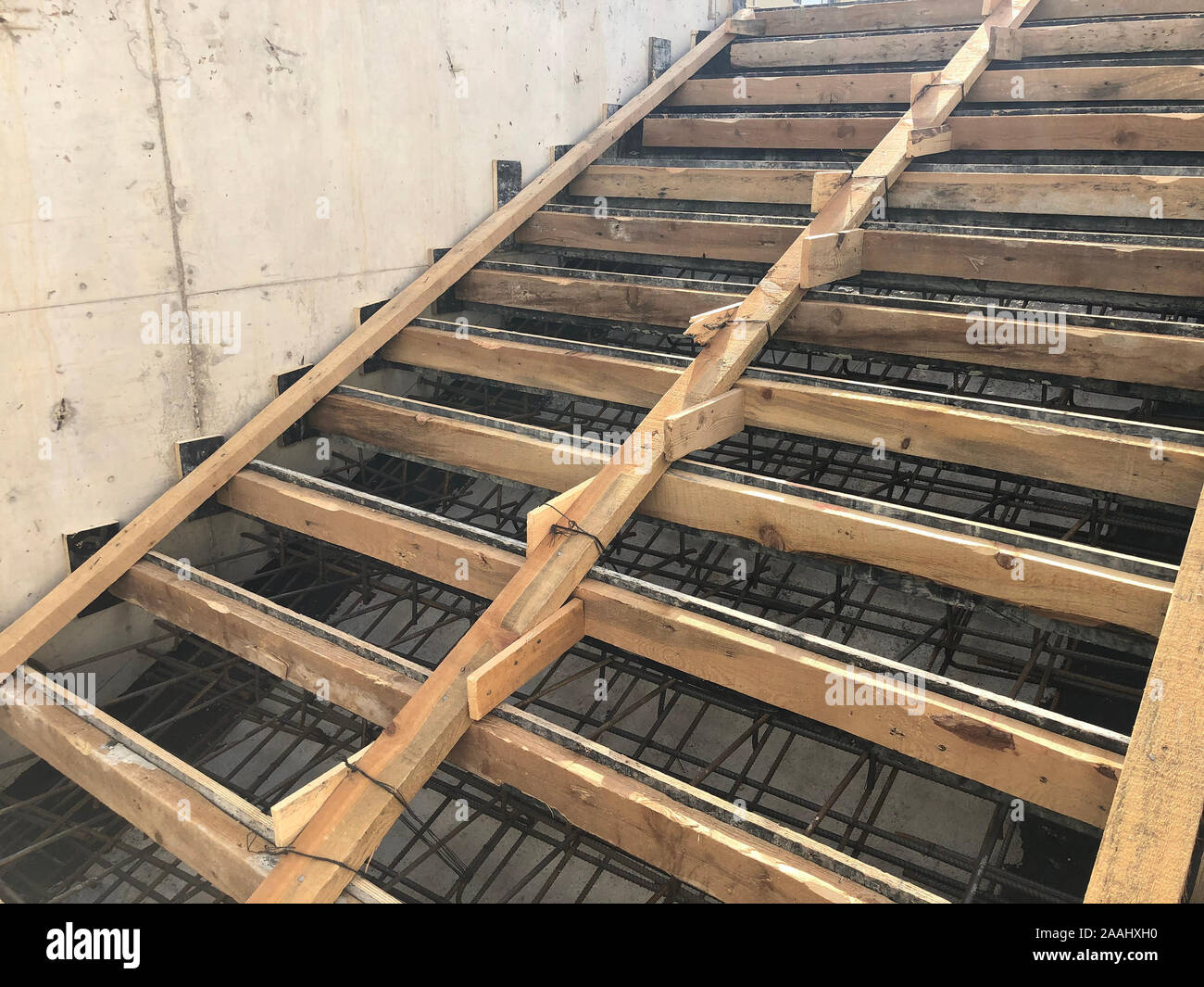 Metal reinforcement and wooden formworks of concrete stairway under ...