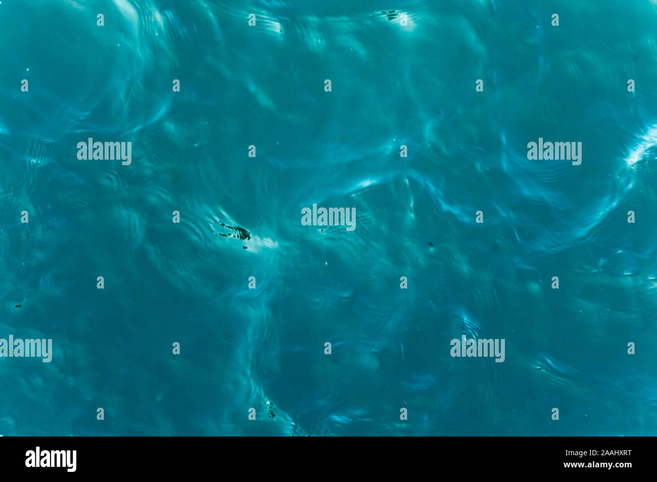Top view of a calm deep blue sea with ripples on the water surface ...