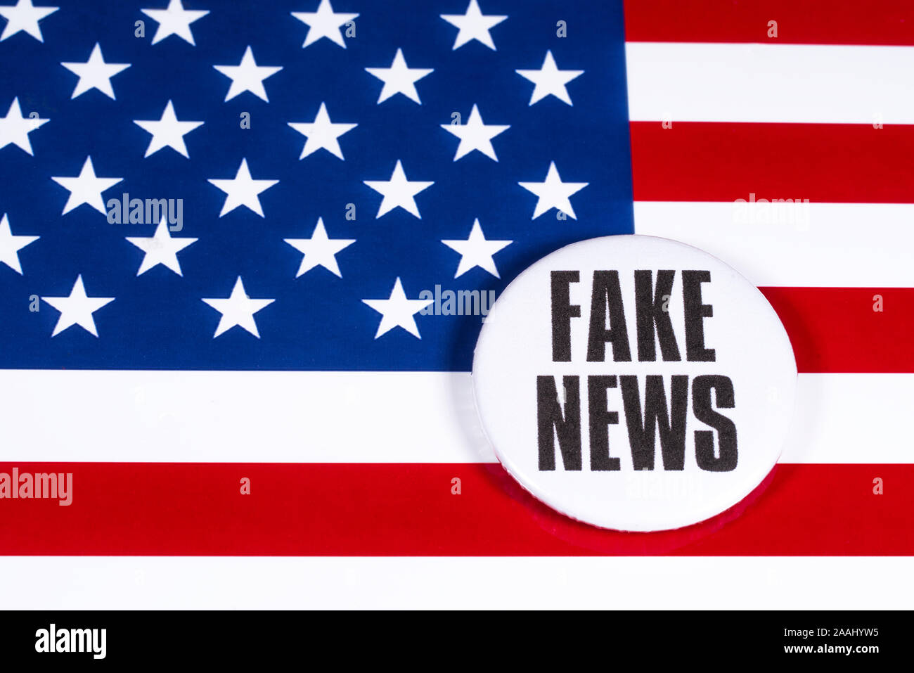 A Fake News pin badge pictured over the flag of the United States of ...