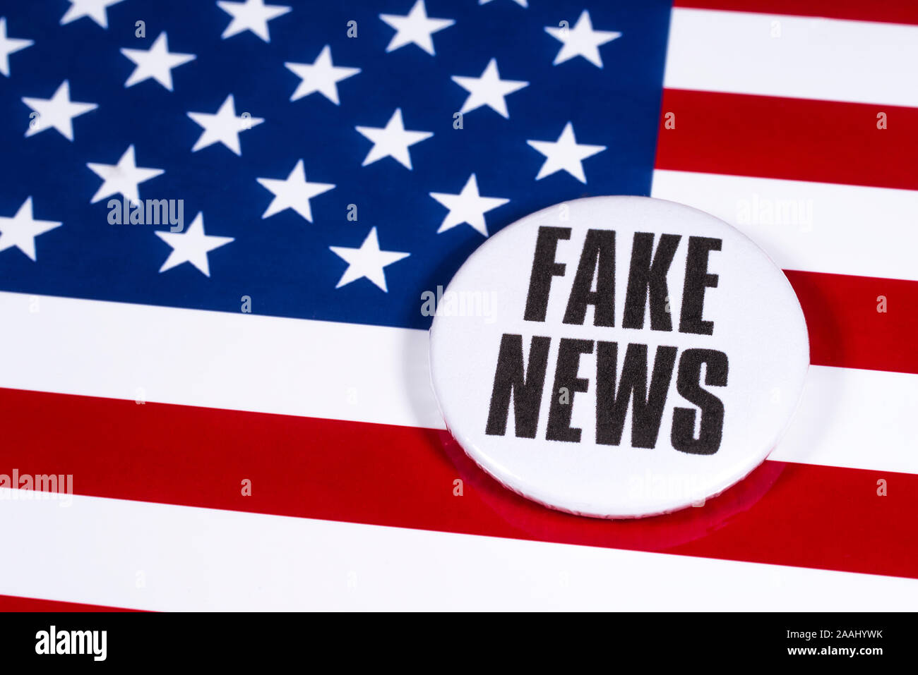 A Fake News pin badge pictured over the flag of the United States of ...