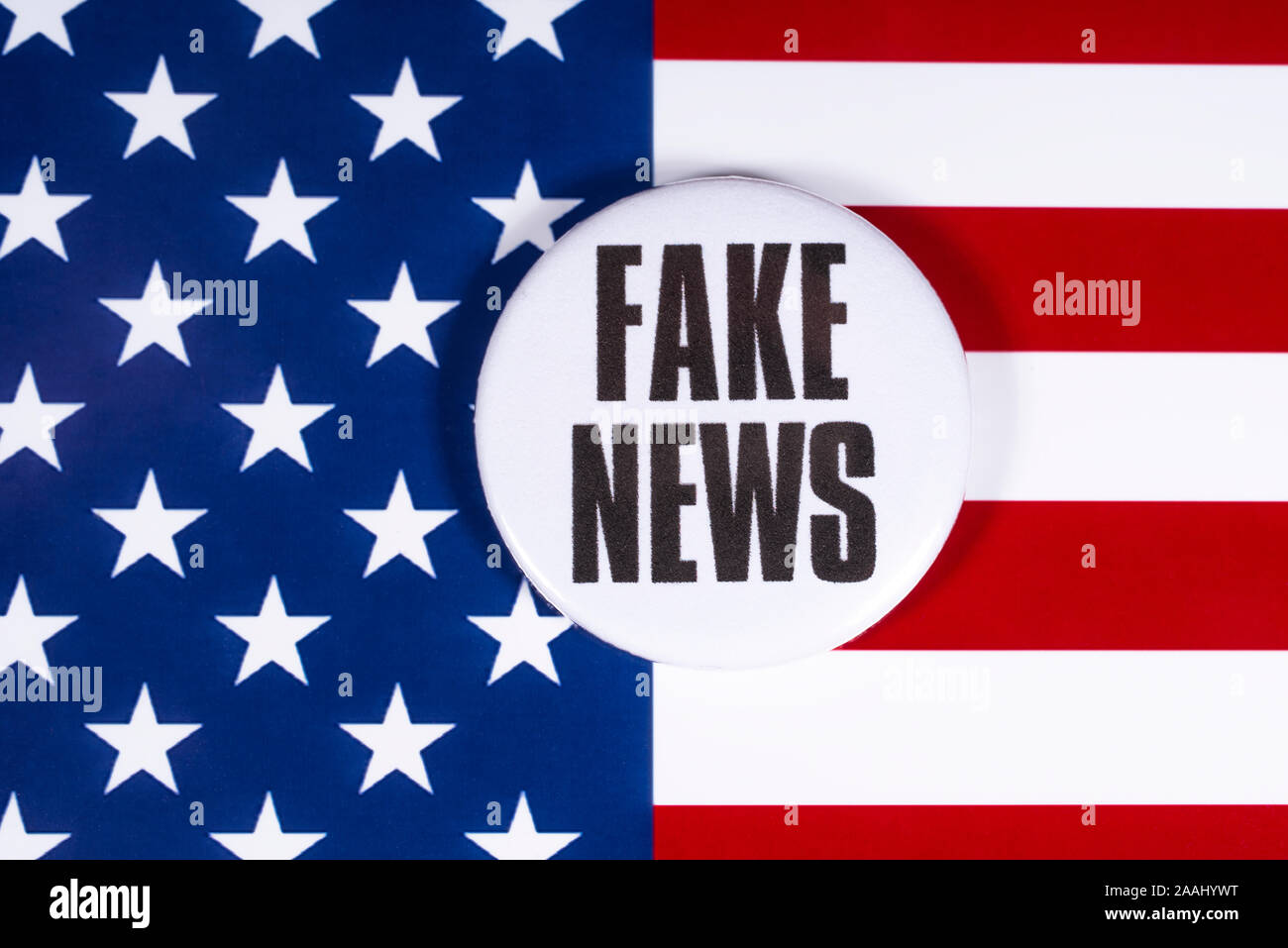 A Fake News pin badge pictured over the flag of the United States of ...