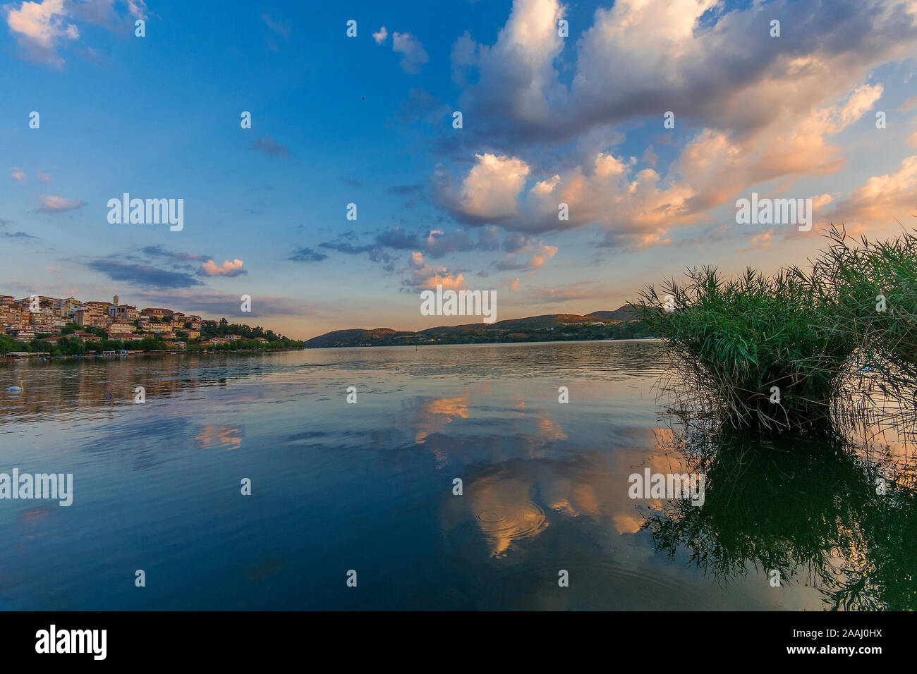 Sunset view of a calm lake reflecting the blue and pink colours of the ...