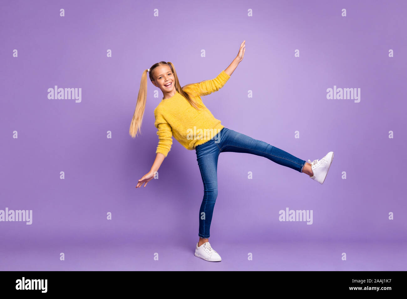 Full body photo of positive cheerful kid have fun raise hands leg enjoy ...
