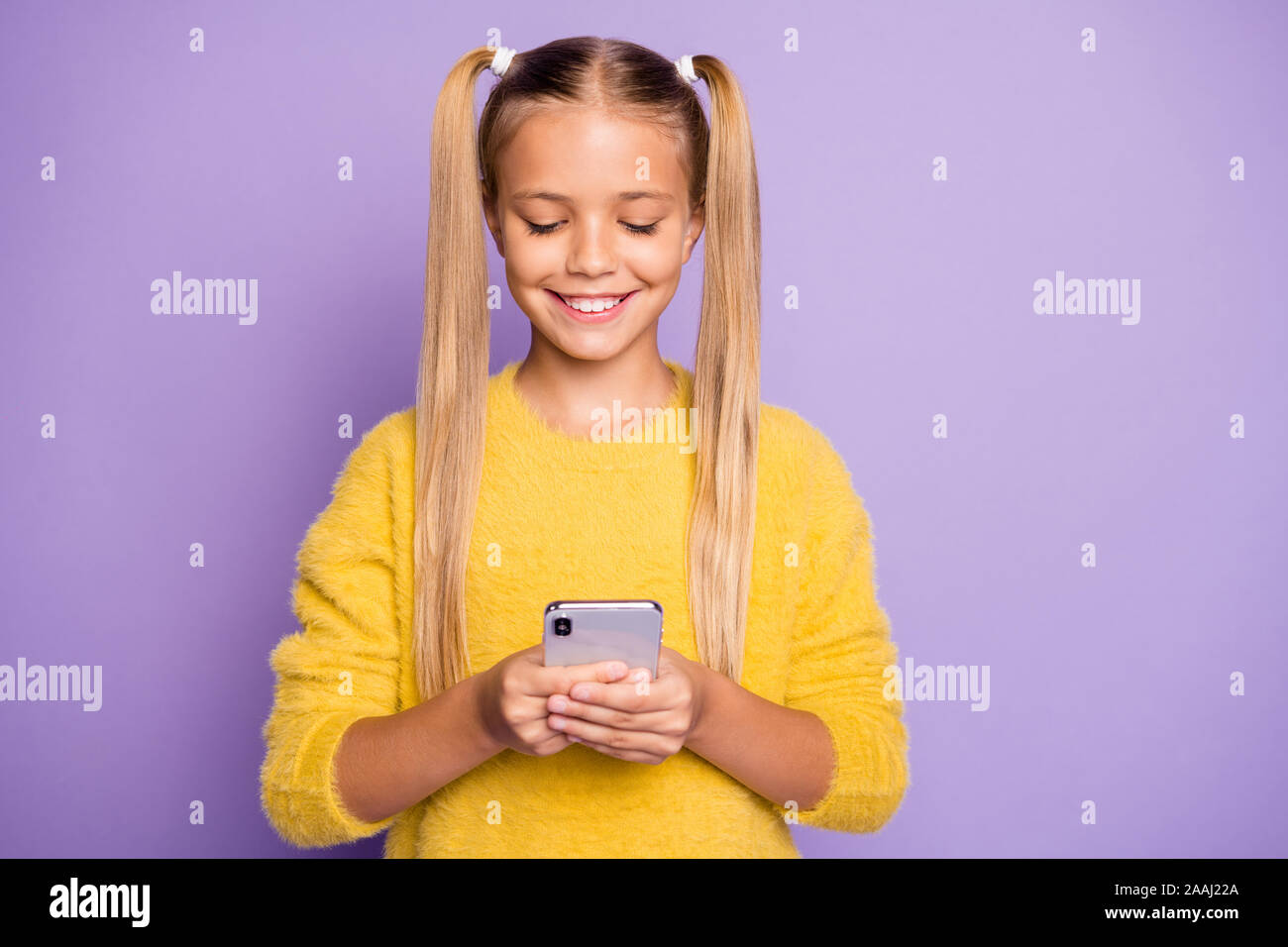 Photo of cheerful positive cute girl smiling toothily browsing through ...