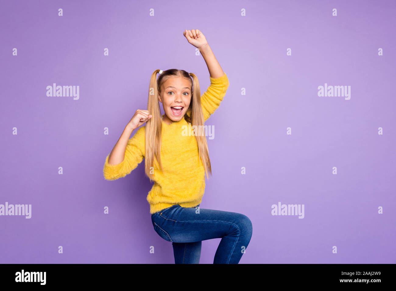 Photo of cheerful positive excited girl wearing yellow sweater jeans ...