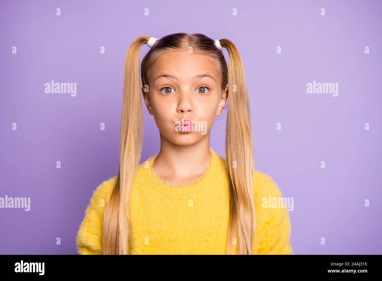 Portrait of confused funky kid made mistake have her lips pouted plump ...