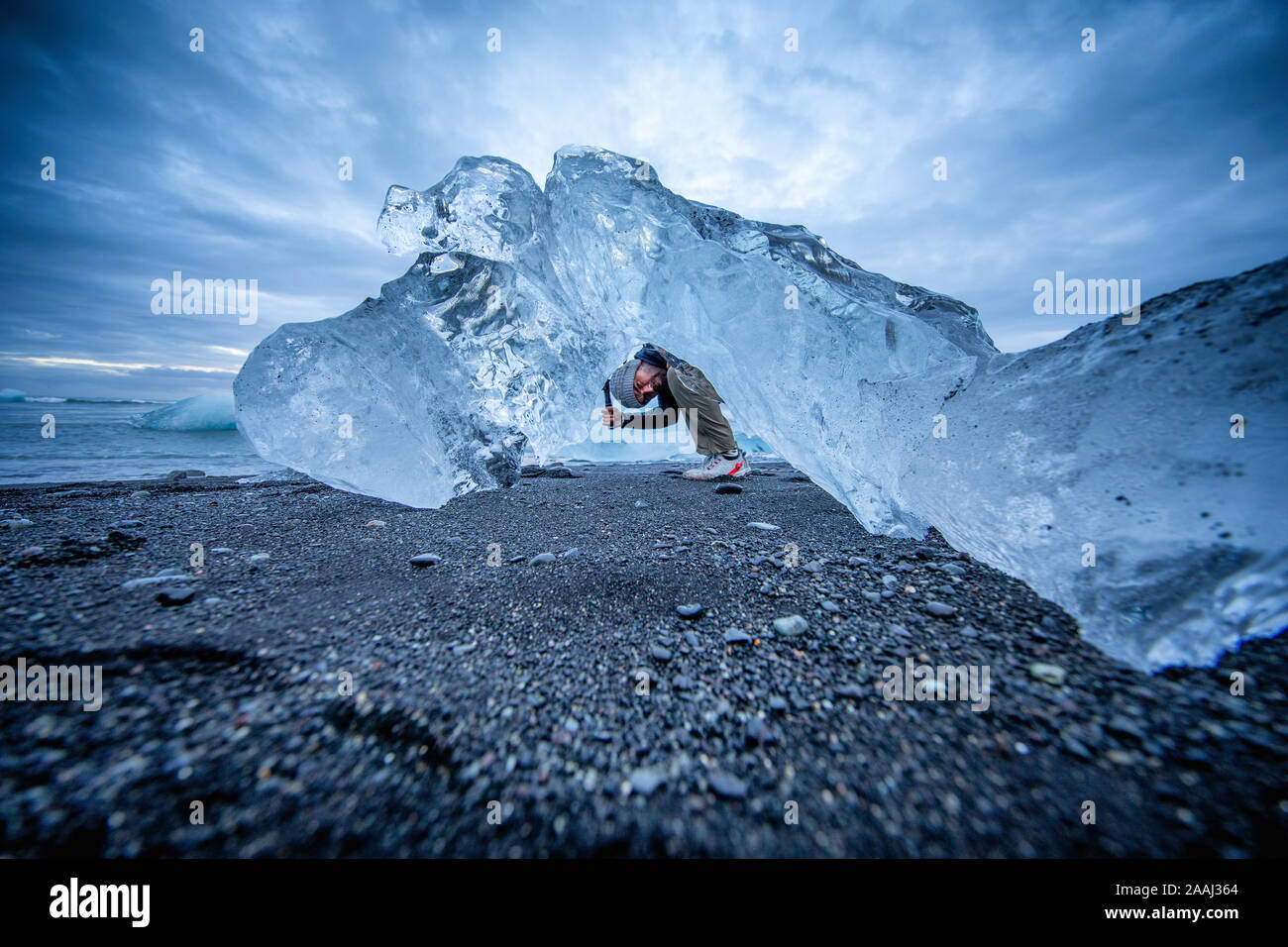 Man exploring ice formations, Diamond beach, Iceland Stock Photo - Alamy