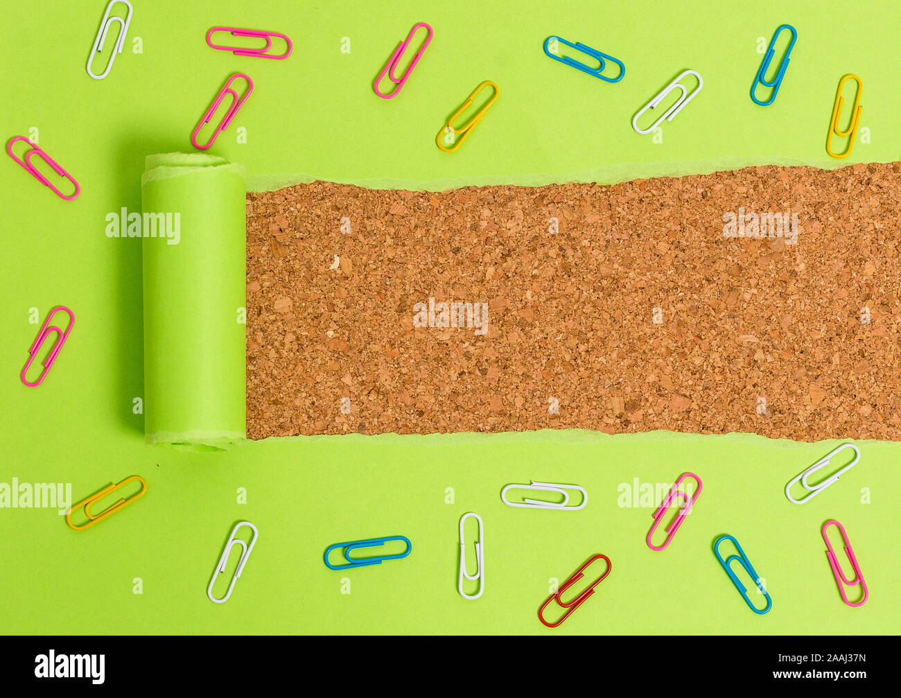 Paper clip and torn cardboard placed above a wooden classic table ...