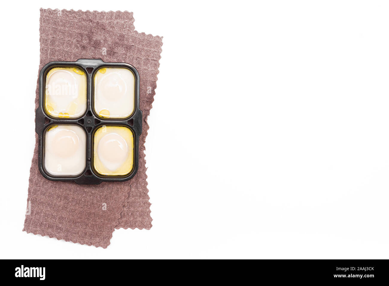 Steamed fried eggs in egg cooker container isolated on white background ...