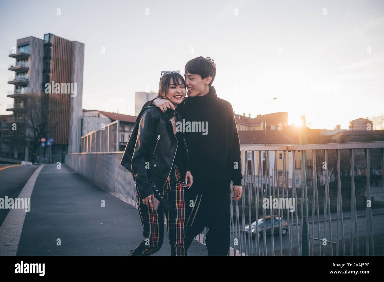 Trendy couple walking over bridge, Milan, Italy Stock Photo - Alamy