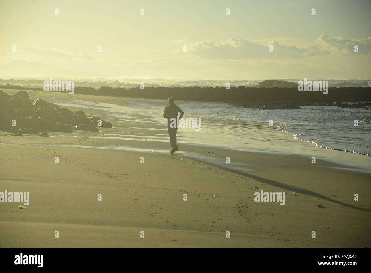 Man running along the beach hi-res stock photography and images - Alamy