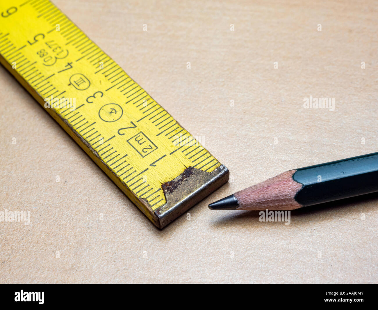 Drawing with a folding rule and pencil on wood Stock Photo - Alamy