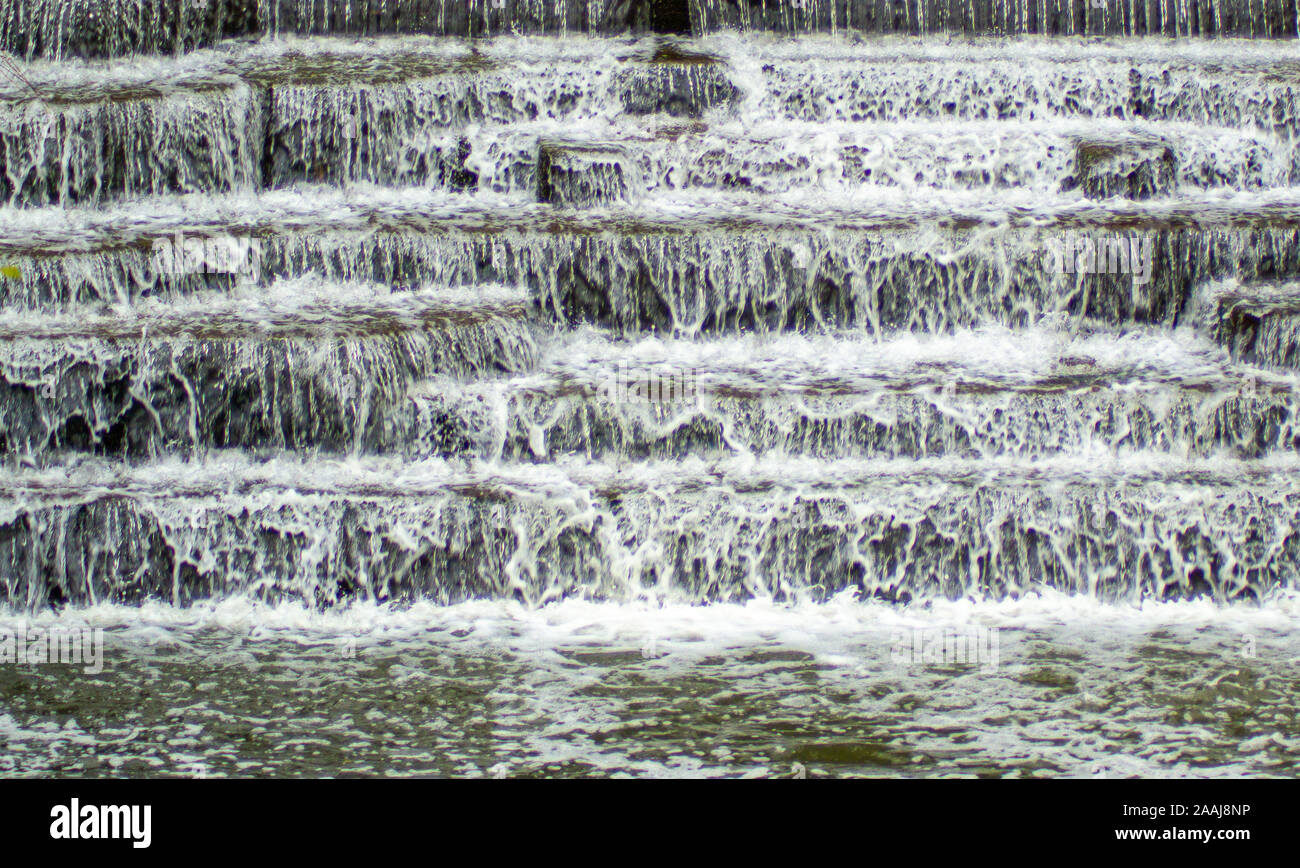 Water Cascading over Weir Steps on canal slipway showing blur blurred ...