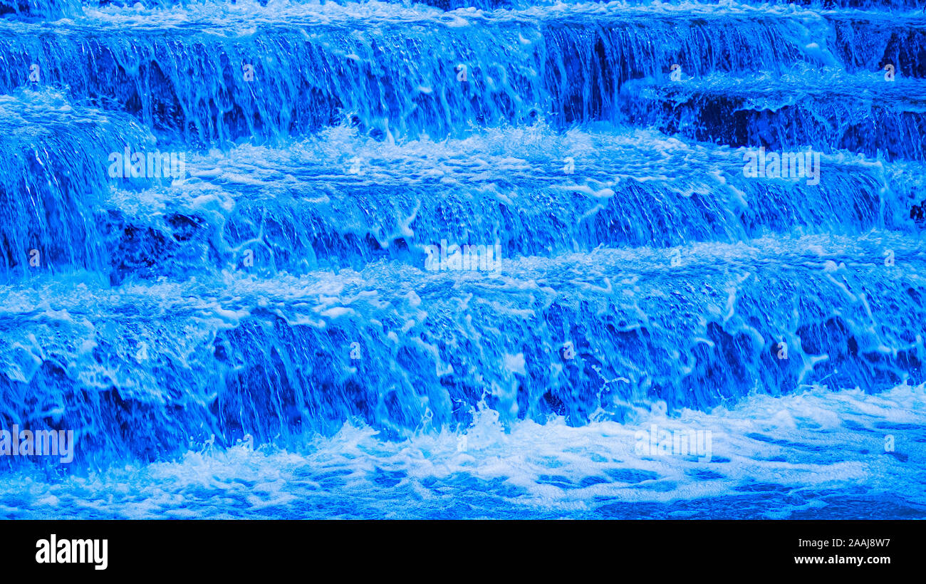 Water Cascading over Weir Steps on canal slipway showing blur blurred ...