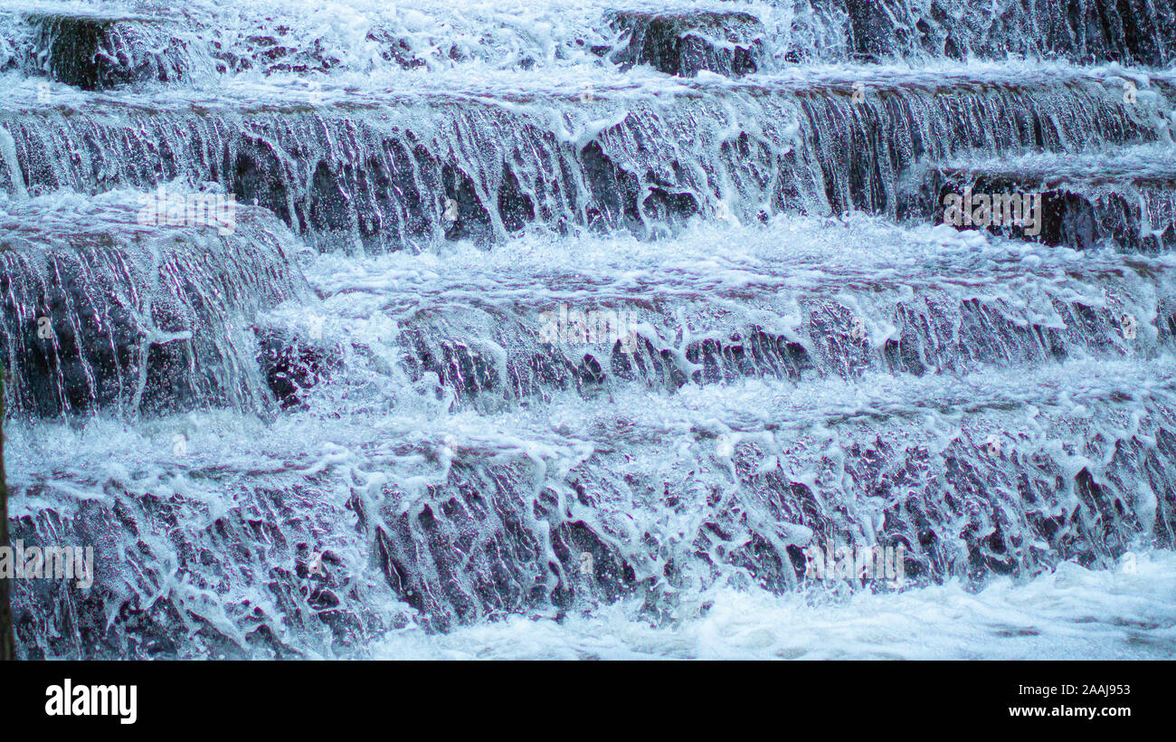 Water Cascading over Weir Steps on canal slipway showing blur blurred ...