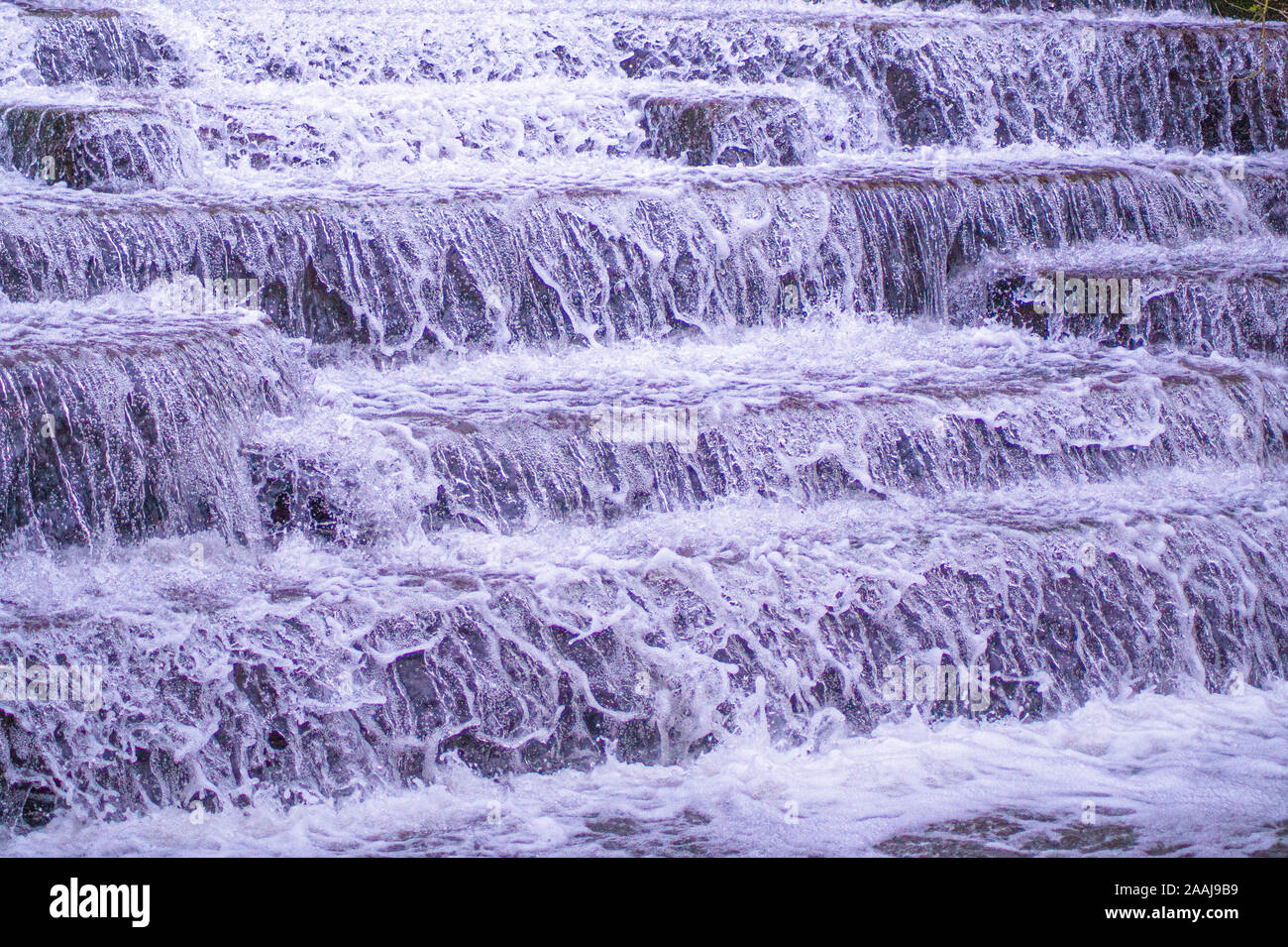 Water Cascading over Weir Steps on canal slipway showing blur blurred ...