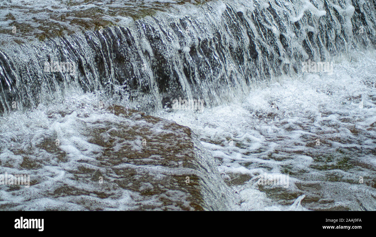 Water Cascading over Weir Steps on canal slipway showing blur blurred ...