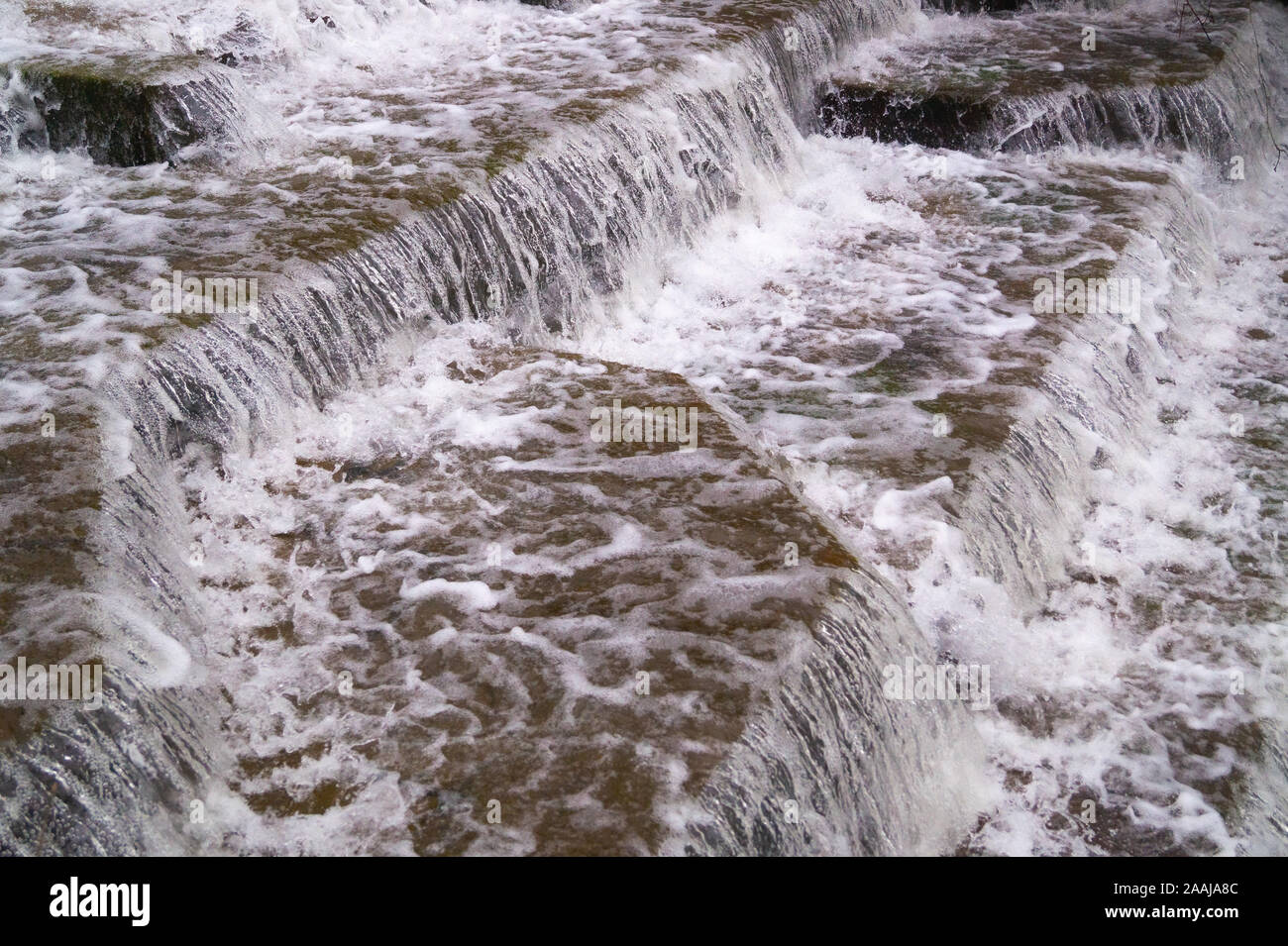 Water Cascading over Weir Steps on canal slipway showing blur blurred ...