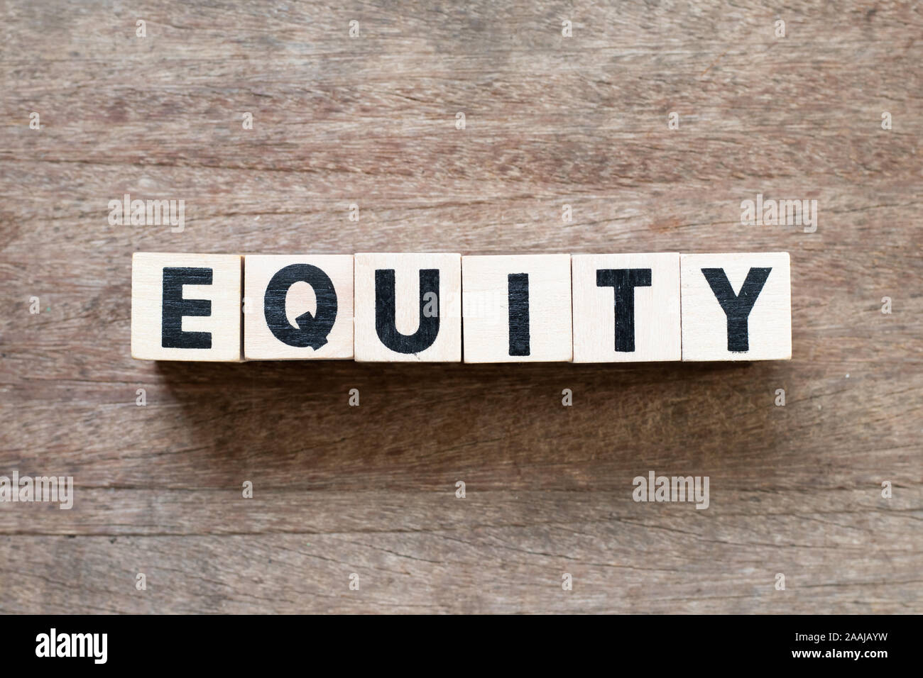 Letter block in word equity on wood background Stock Photo - Alamy