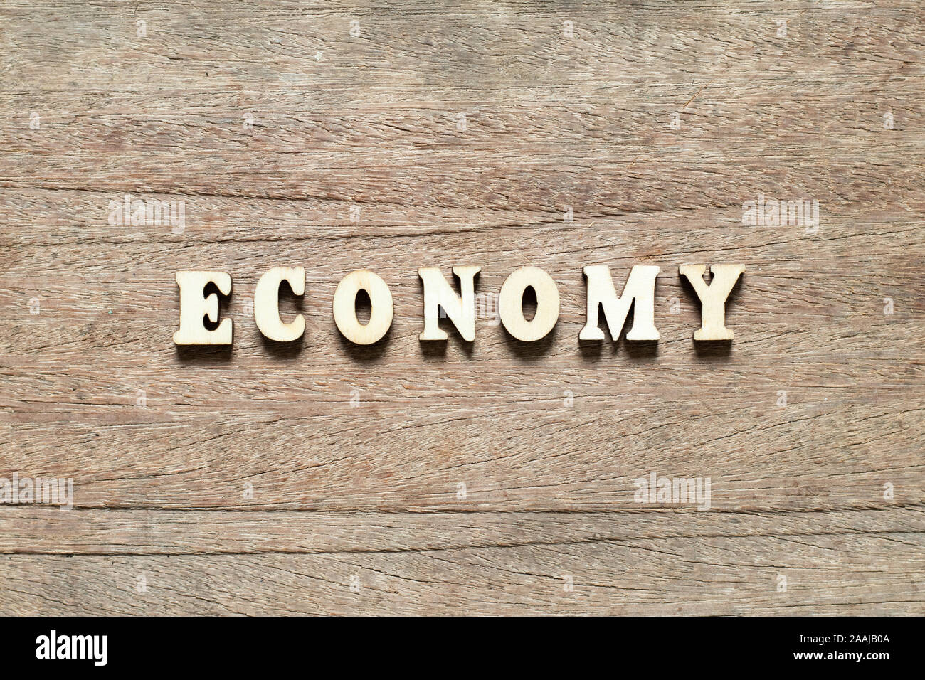 Letter block in word economy on wood background Stock Photo - Alamy