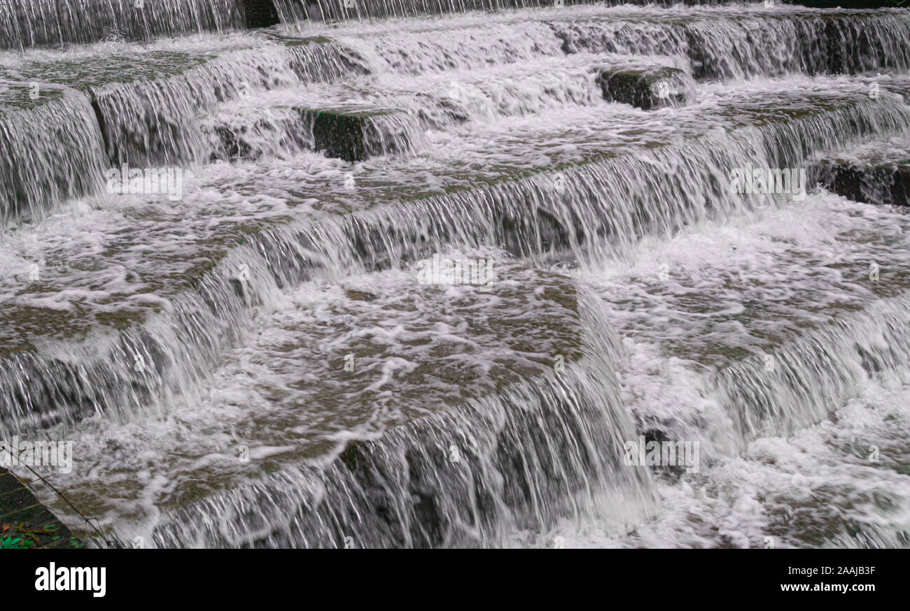 Water Cascading over Weir Steps on canal slipway showing blur blurred ...