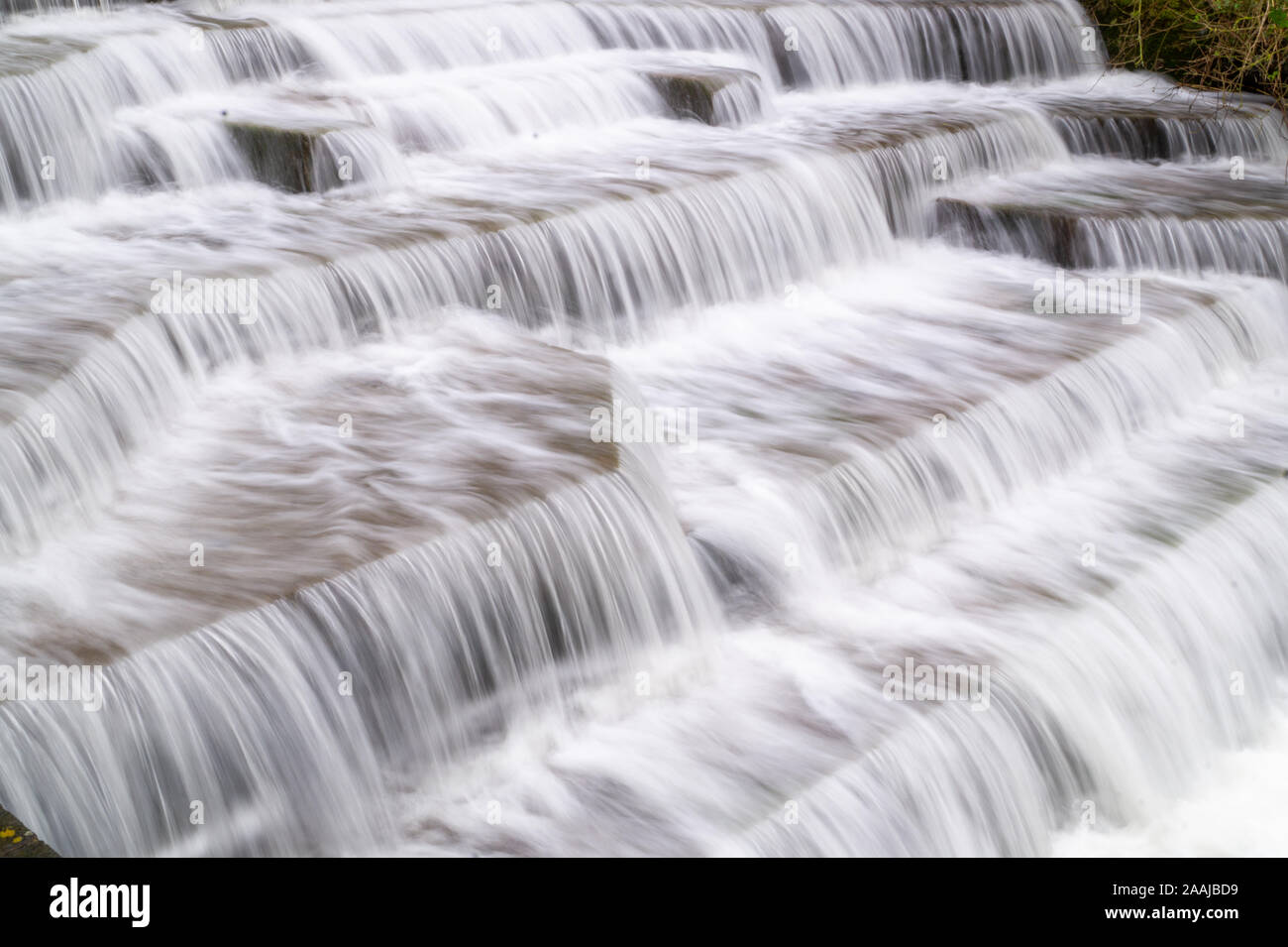 Water Cascading over Weir Steps on canal slipway showing blur blurred ...