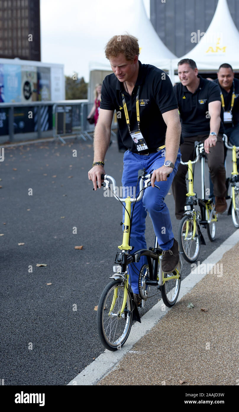 Prince Harry riding a Brompton small wheeled bicycle around the Arena ...