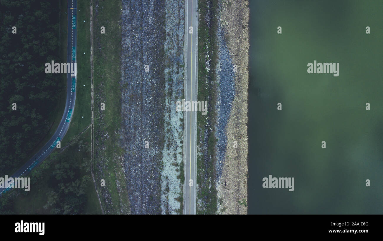 Top view of road with dam near by. have path of forest, street and ...