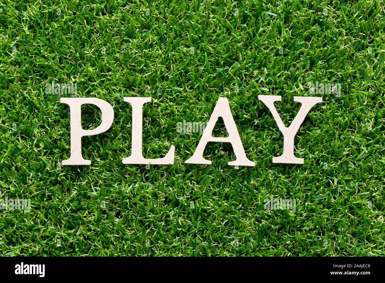Wood alphabet in word play on artificial green grass background Stock ...