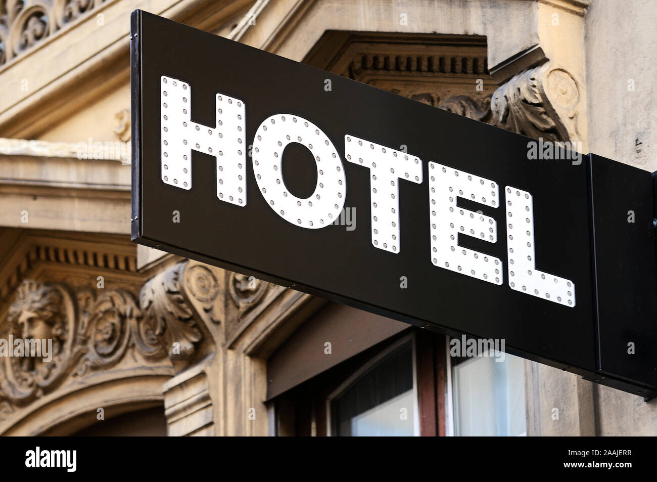 Illuminated urban hotel sign Stock Photo - Alamy